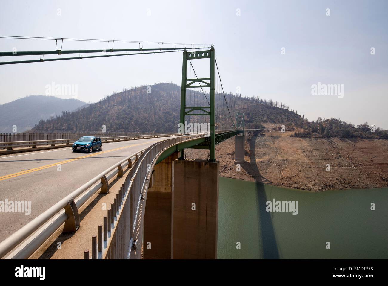A car passes over the Bidwell Bar Bridge in Lake Oroville as water levels remain low due to ...