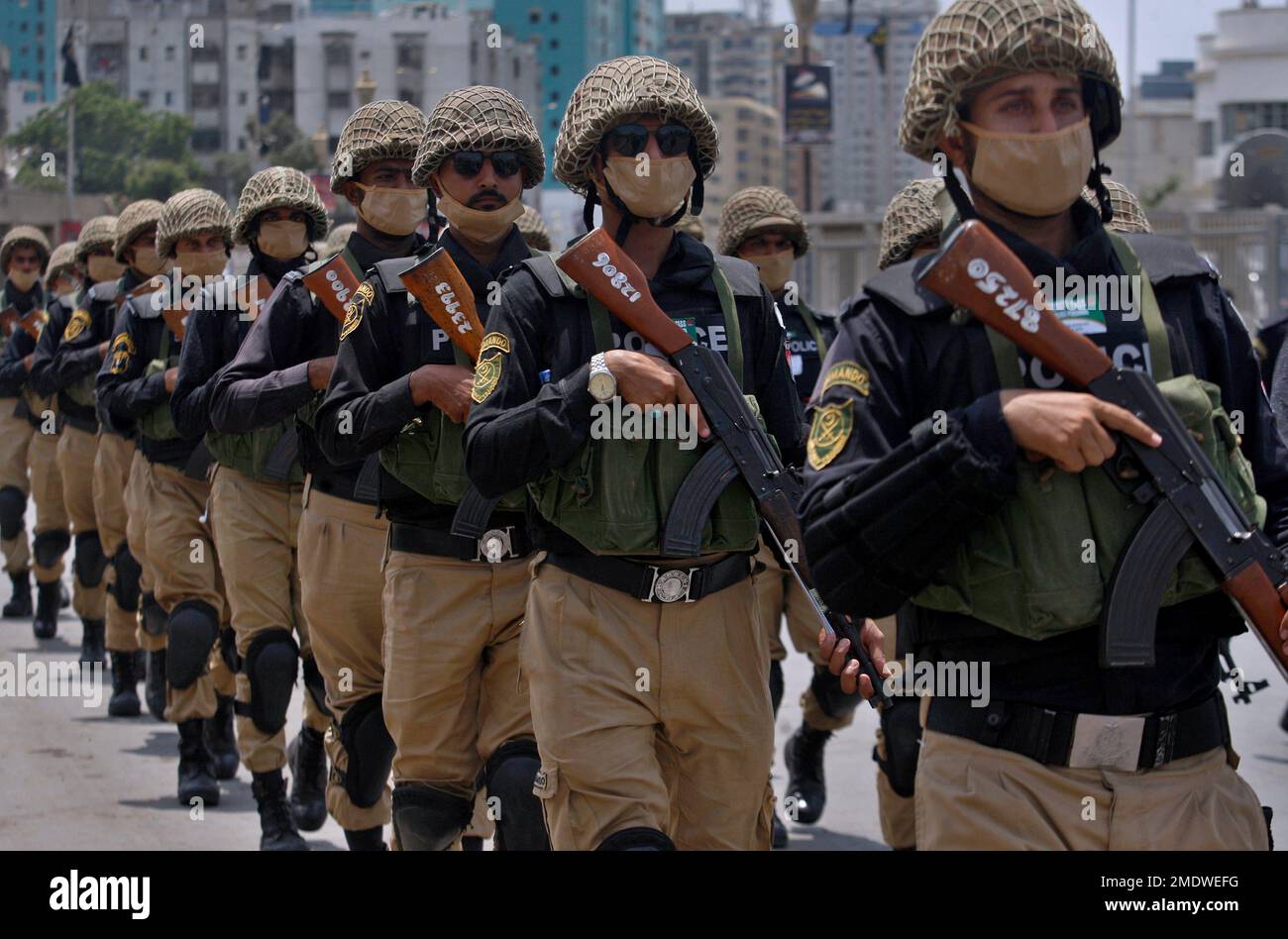 Police commandos guard Shiite Muslims during a Muharram procession, in ...