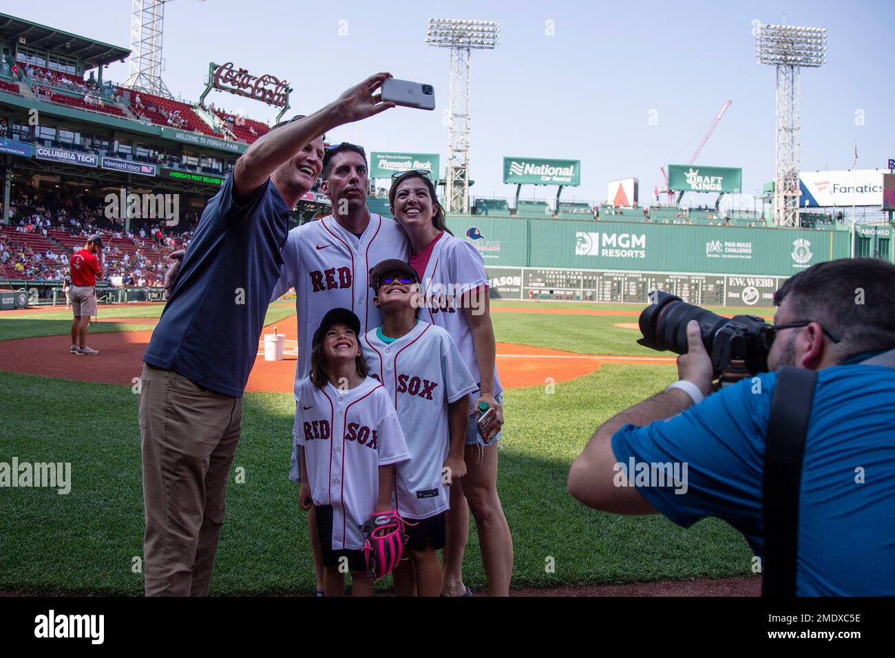 Boston Red Sox president Sam Kennedy, left, takes a group selfie with ...