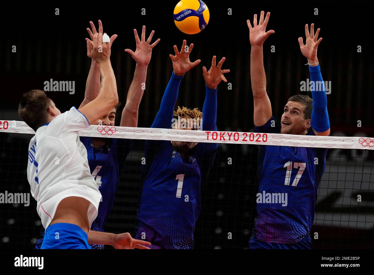 Dmitry Volkov, of the Russian Olympic Committee, spikes a ball against ...