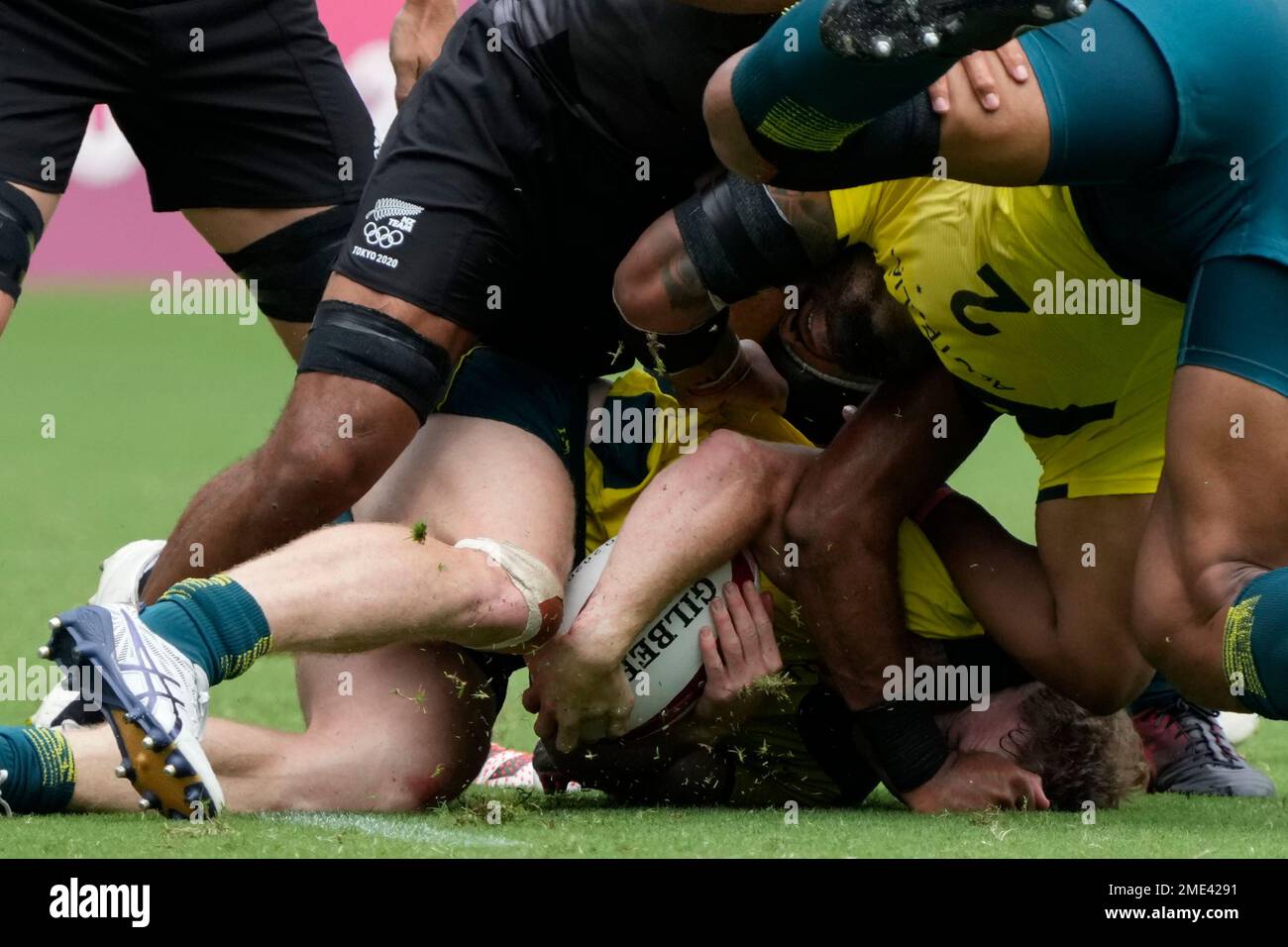 Australia's Henry Hutchison clings to the ball at the bottom of a pile ...
