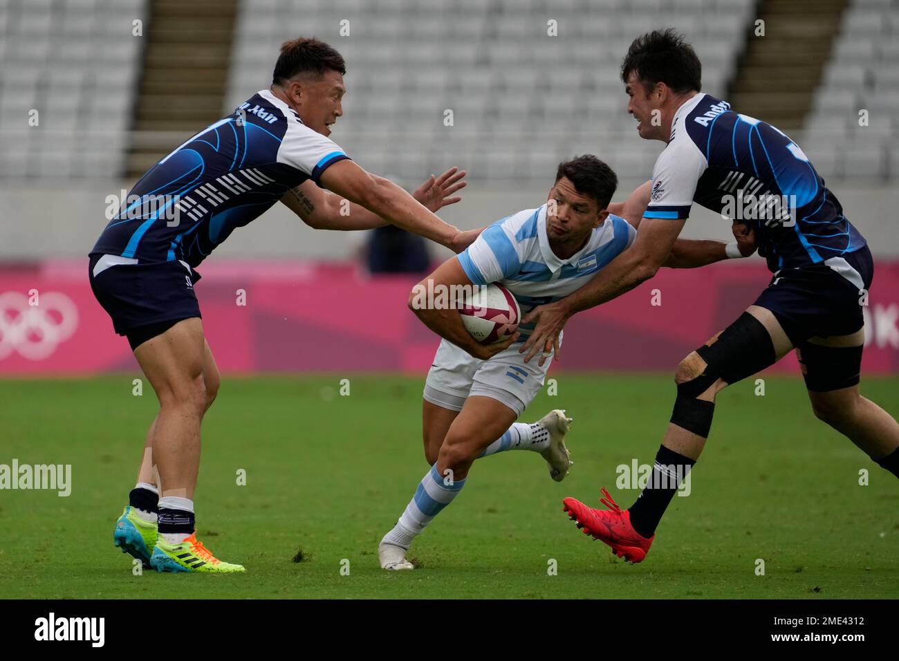 Argentina's Lautaro Bazan Velez, center, is challenged by South Korea's ...
