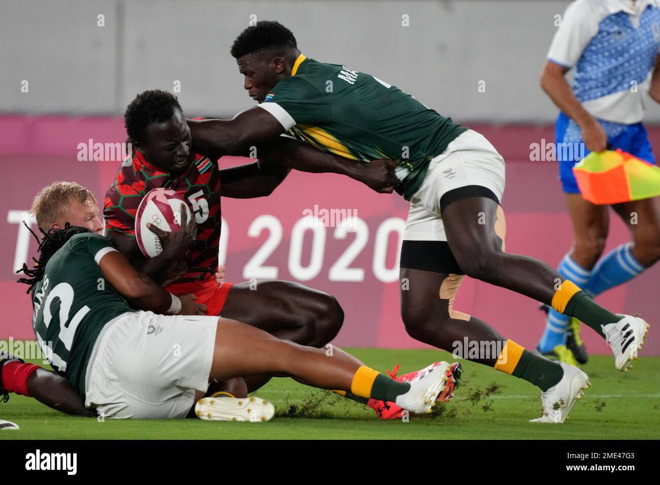 Kenya's Billy Odhiambo, center, spars for the ball with South Africa's ...