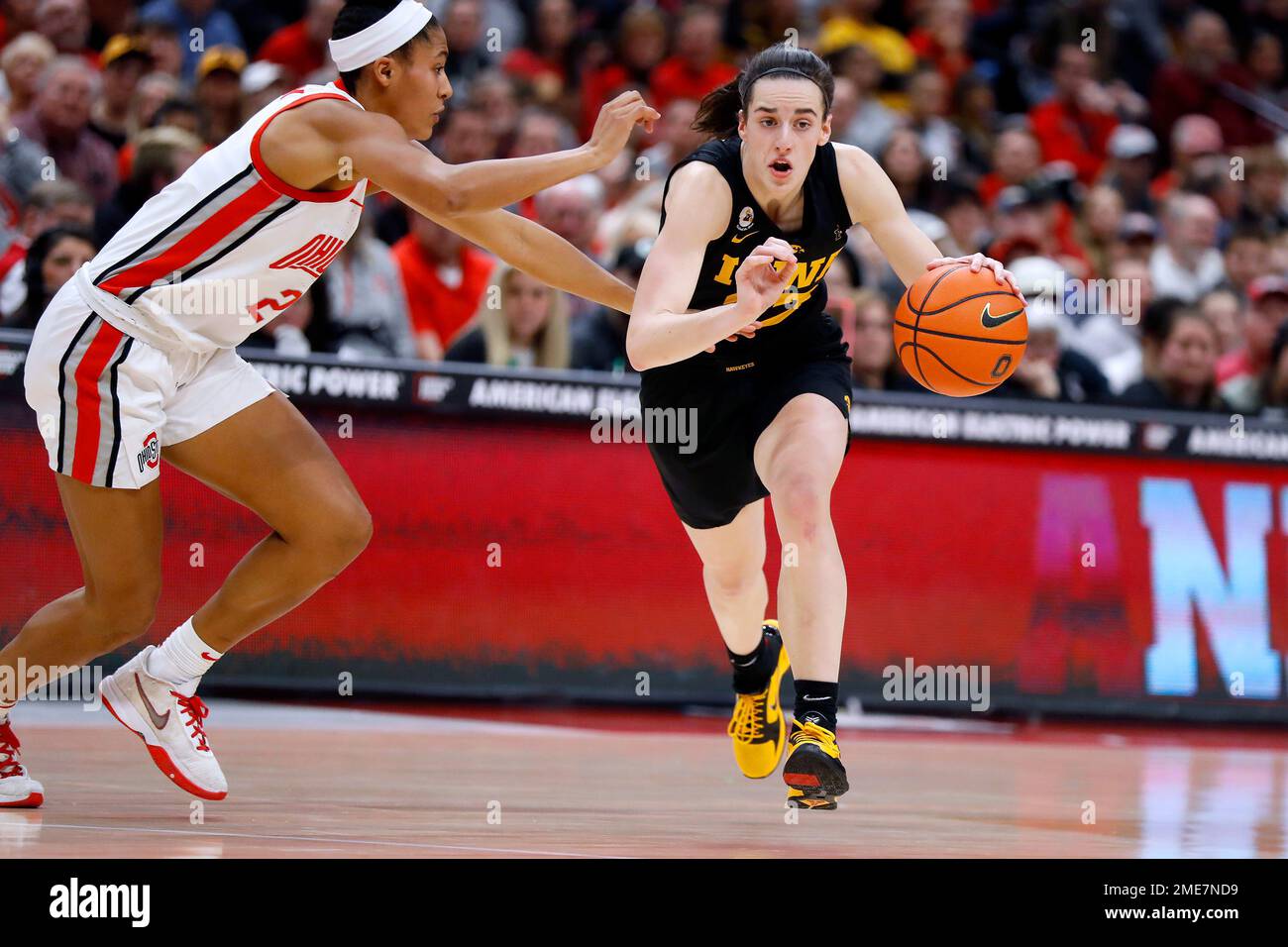 Iowa guard Caitlin Clark, right, dribbles past Ohio State forward ...