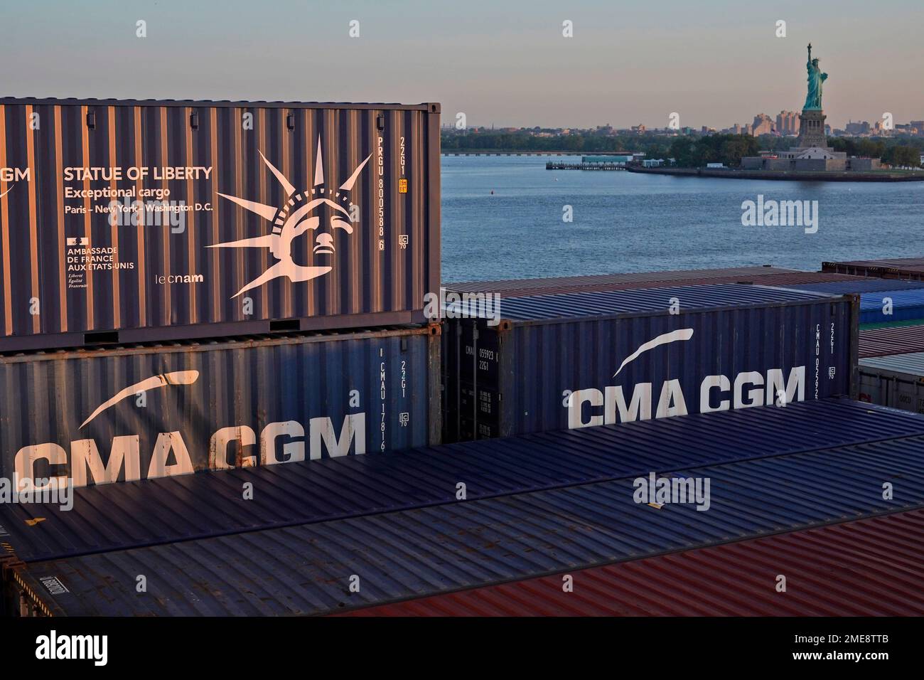 A container carrying a replica of the Statue of Liberty, left, passes ...