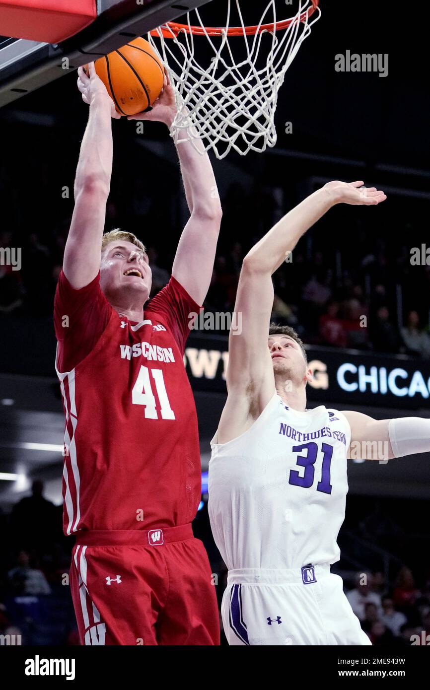 Wisconsin forward Steven Crowl, left, goes up to dunk against ...