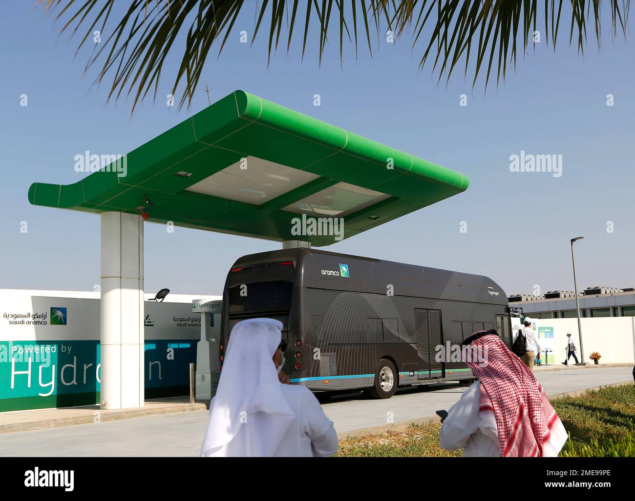 Saudis watch a Hydrogen powered bus as it refuels at the recently inaugurated hydrogen fueling ...