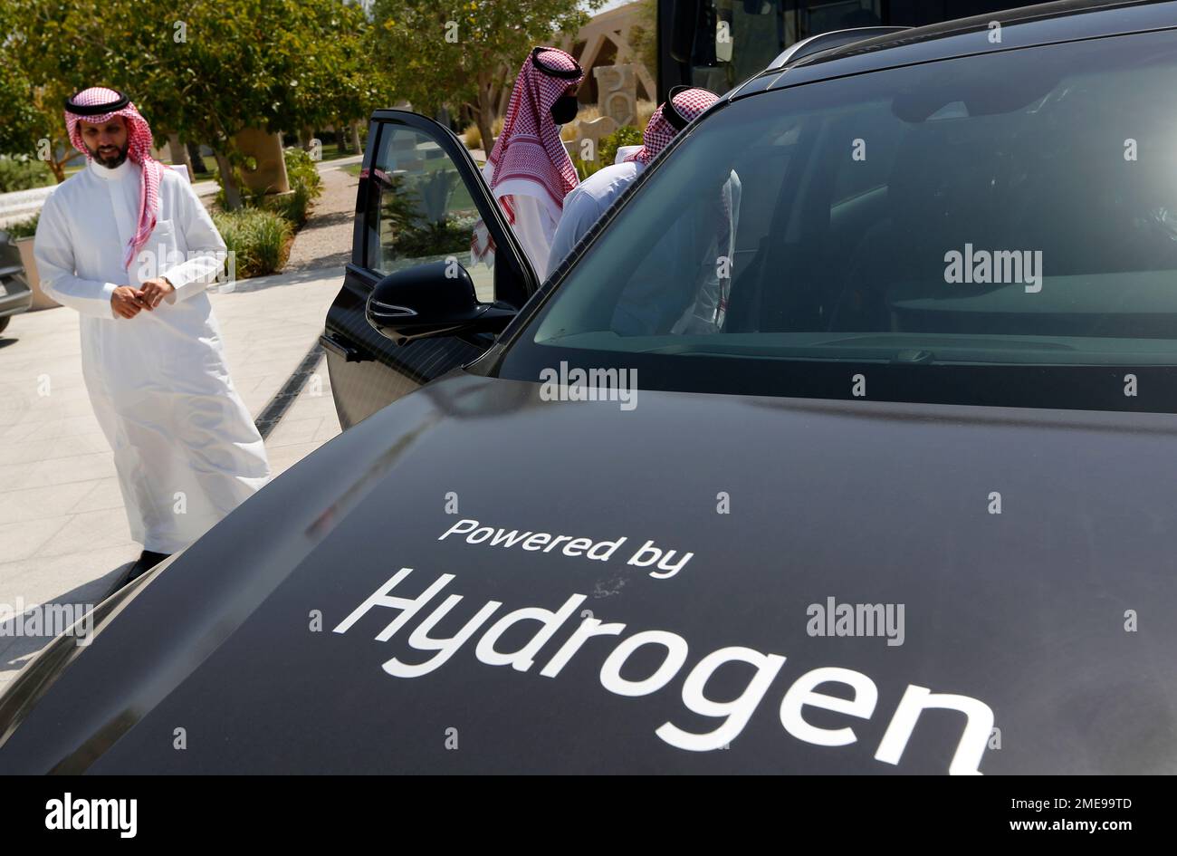 Saudis watch a hydrogen powered car during a test drive organized by ...