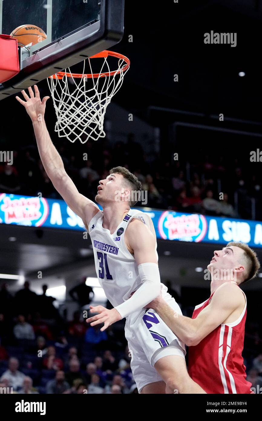Northwestern forward Robbie Beran, left, drives to the basket past ...