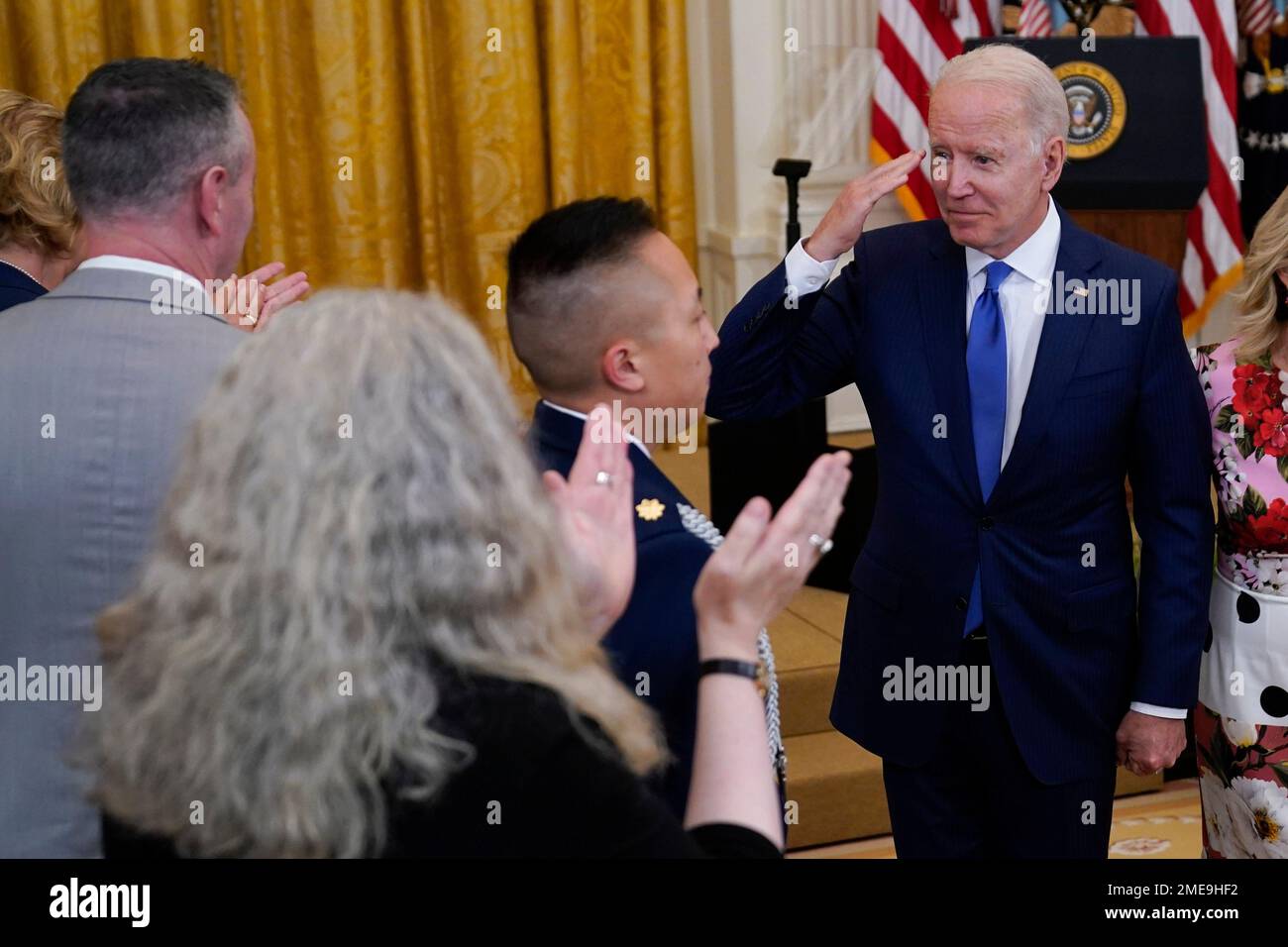President Joe Biden salutes Air Force Lt. Col. Bree Fram after speaking ...