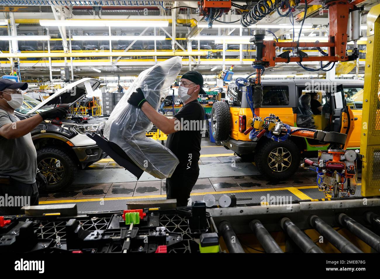 An assembly line worker works on a 2021 Ford Bronco on the line at ...