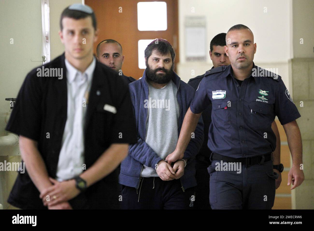 FILE - Yosef Haim Ben David, center, arrives at court in Jerusalem on ...