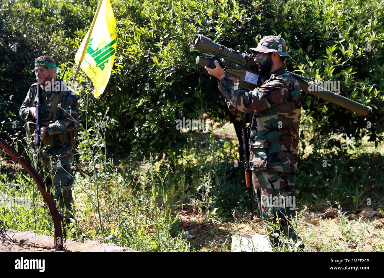 FILE - In this April 20, 2017 file photo, a Hezbollah fighter holds an ...