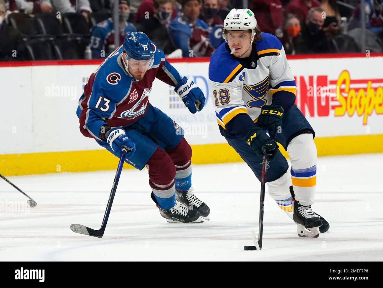 St. Louis Blues center Robert Thomas, right, piks up the puck as ...