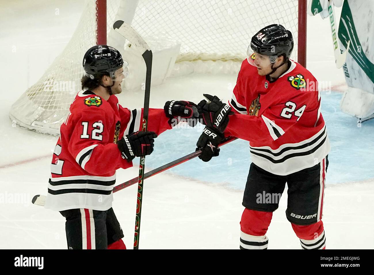 Chicago Blackhawks' Alex DeBrincat (12) and Pius Suter celebrate Suter ...