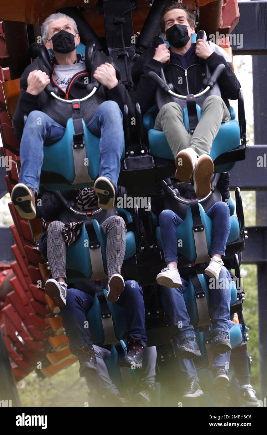 People ride on an amusement at the Walibi Amusement Park in Wavre ...