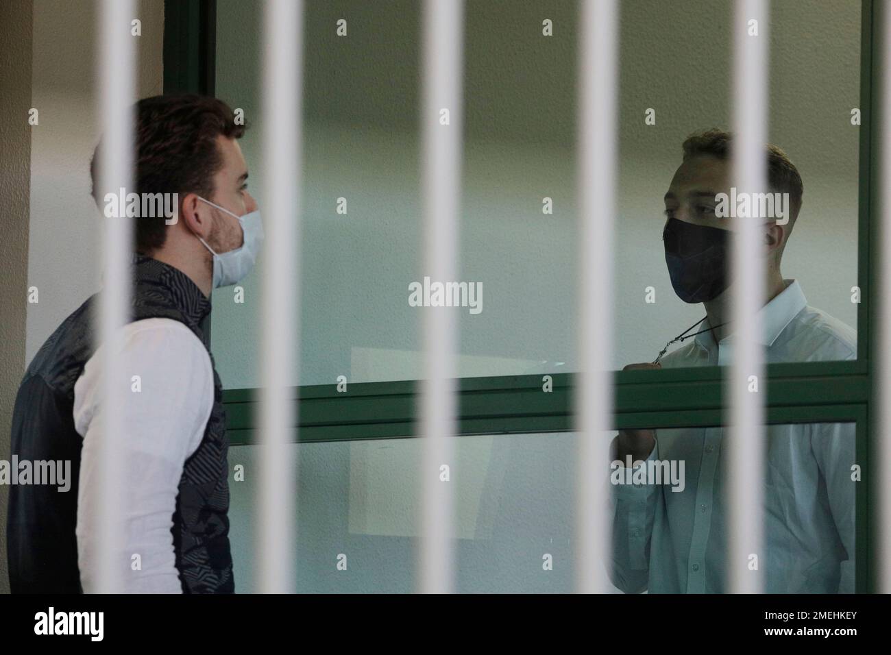 Finnegan Lee Elder, right, shows a crucifix to co-defendant Gabriel ...