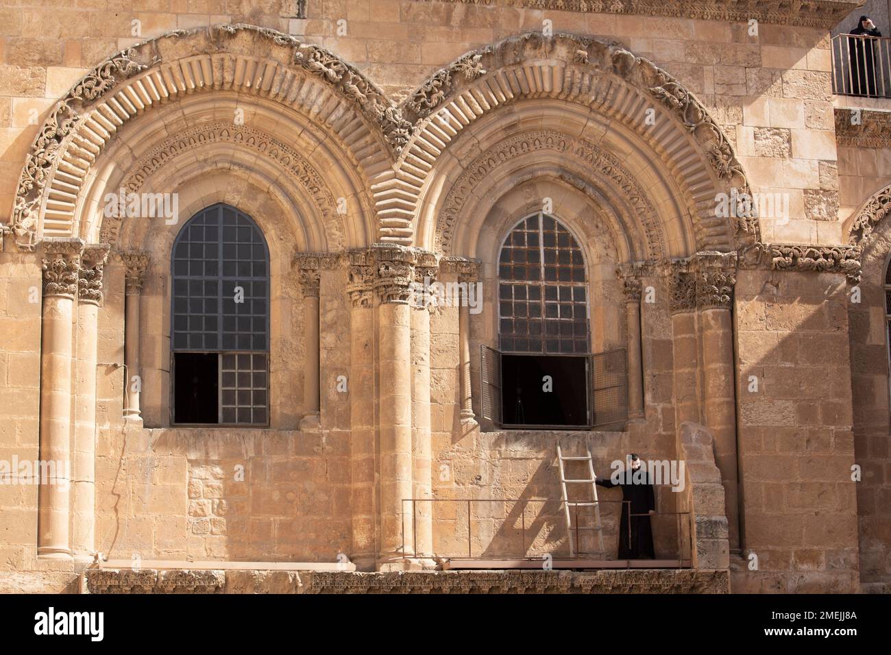 A priest stands next to the "immovable ladder," during the Greek ...