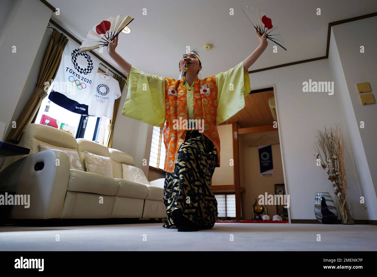 Olympic fan Kyoko Ishikawa shows her cheering at her home Saturday ...