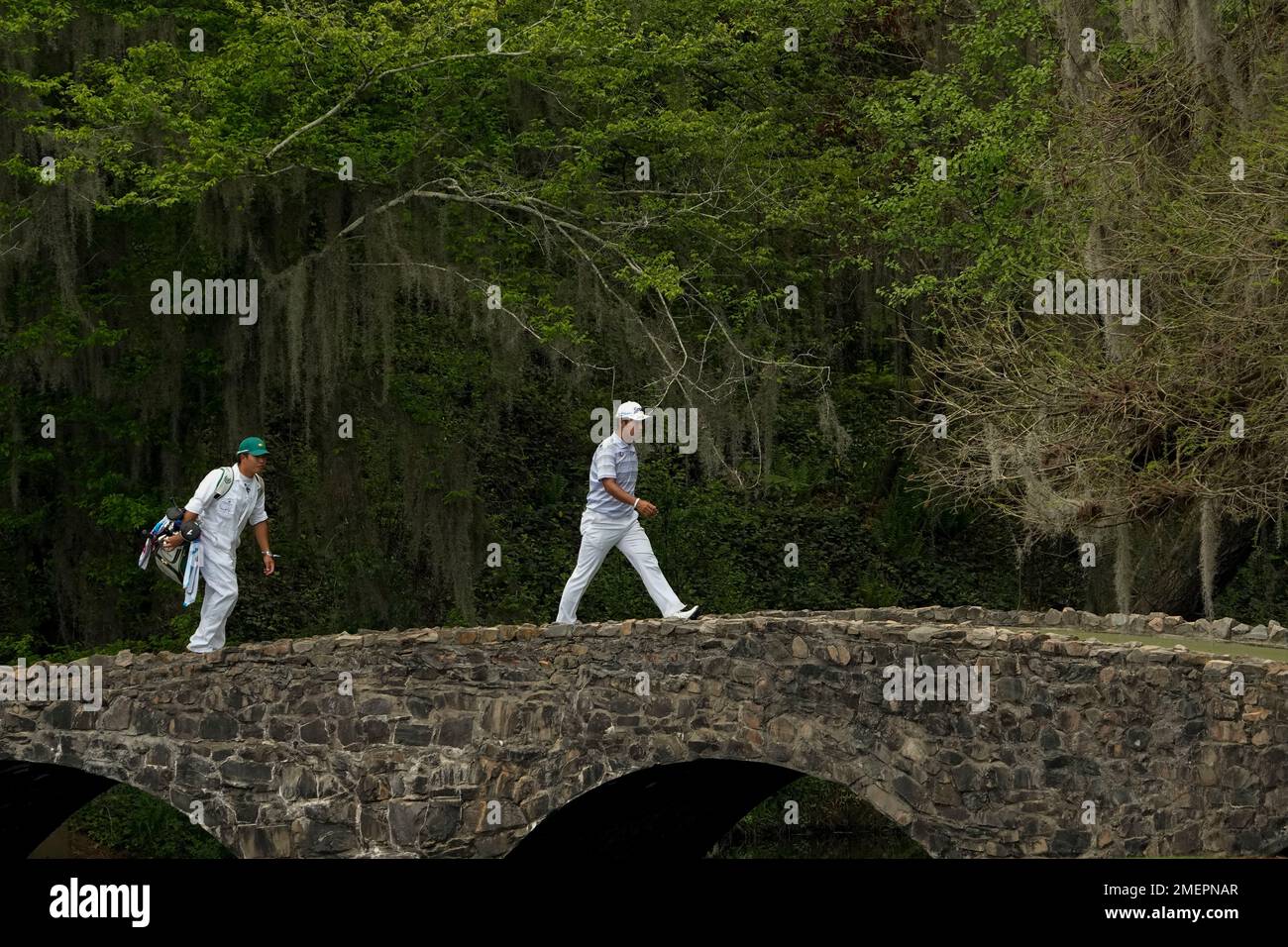 Hideki Matsuyama, of Japan, walks over the Nelson Bridge with his ...