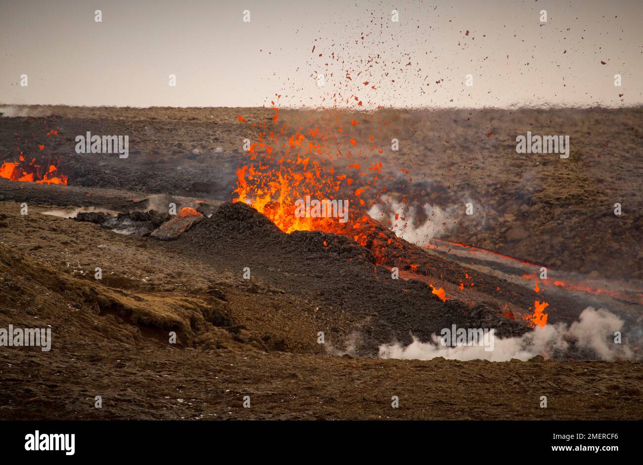 Steam and lava spurt from a new fissure on a volcano on the Reykjanes ...