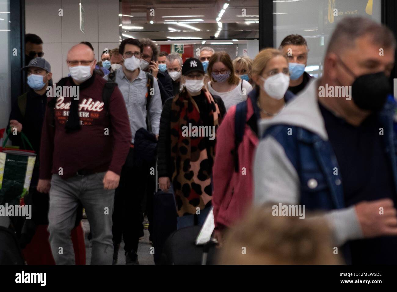 Passengers wearing face masks arrive at Palma de Mallorca Airport on ...