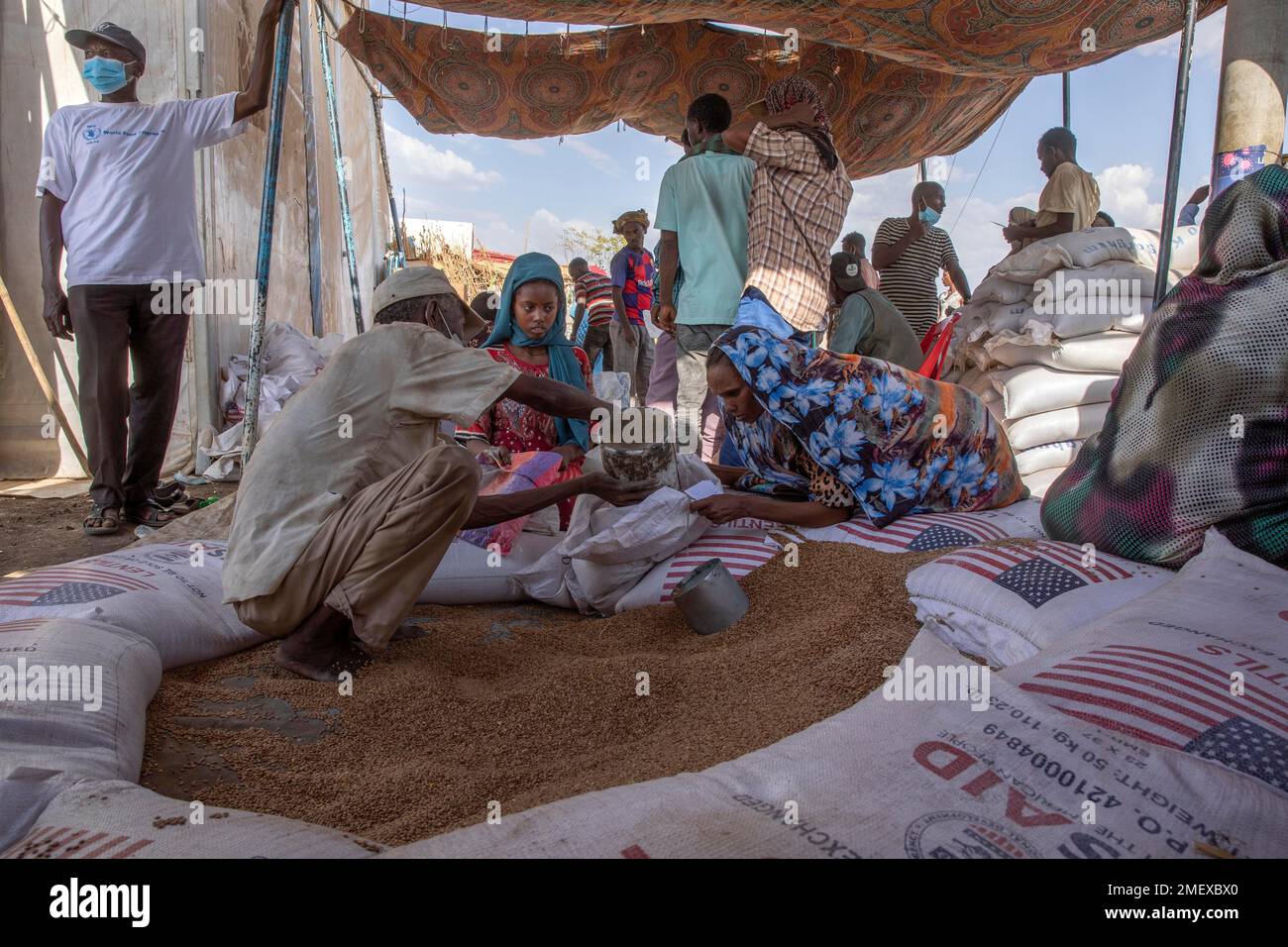 Tigrayan refugees collect food rations from USAID at Hamdeyat ...