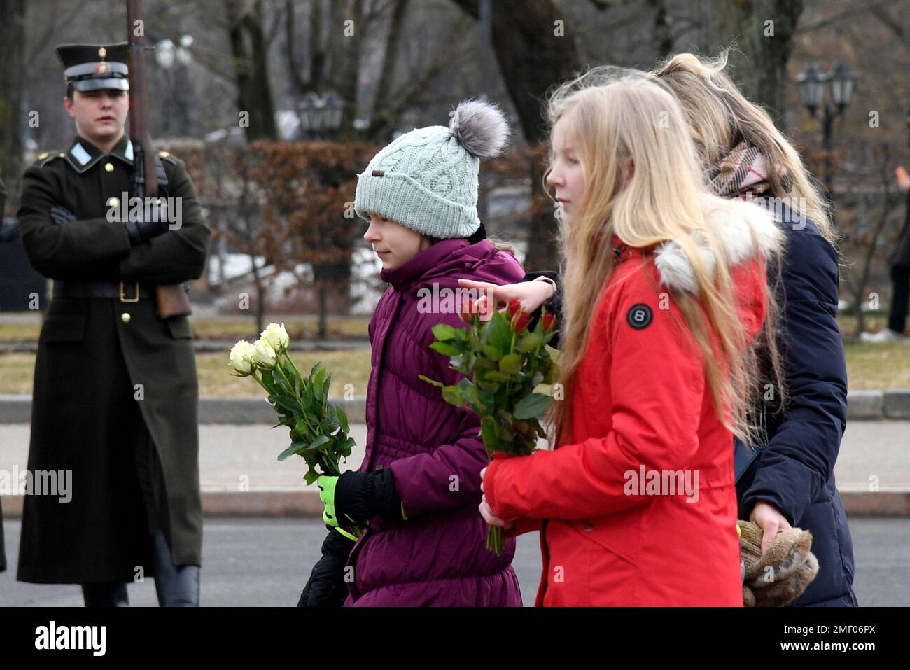Girls walk to lay flowers at the Freedom Monument to commemorate ...
