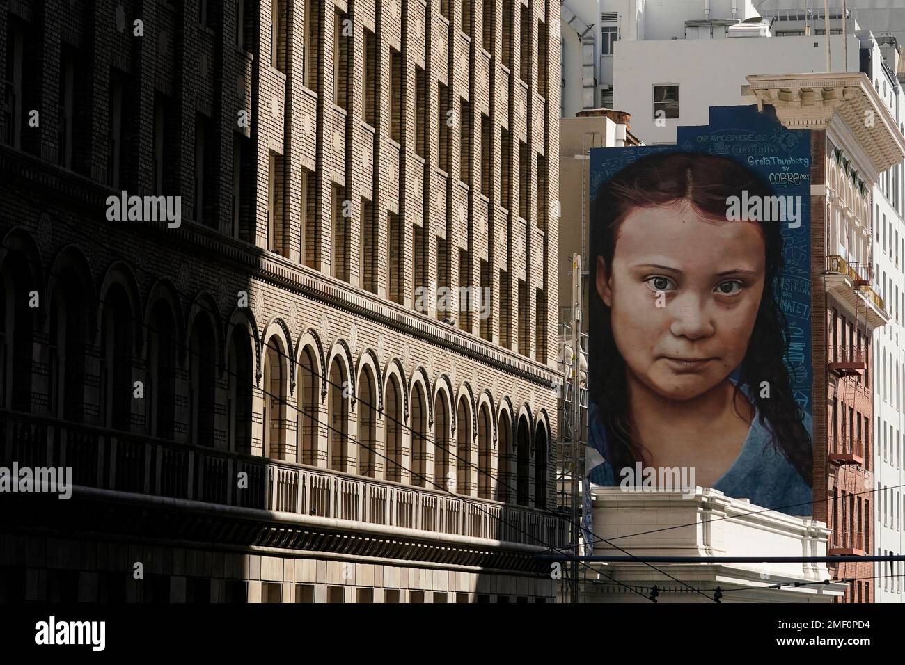 A mural on the side of a building depicting Swedish climate activist ...