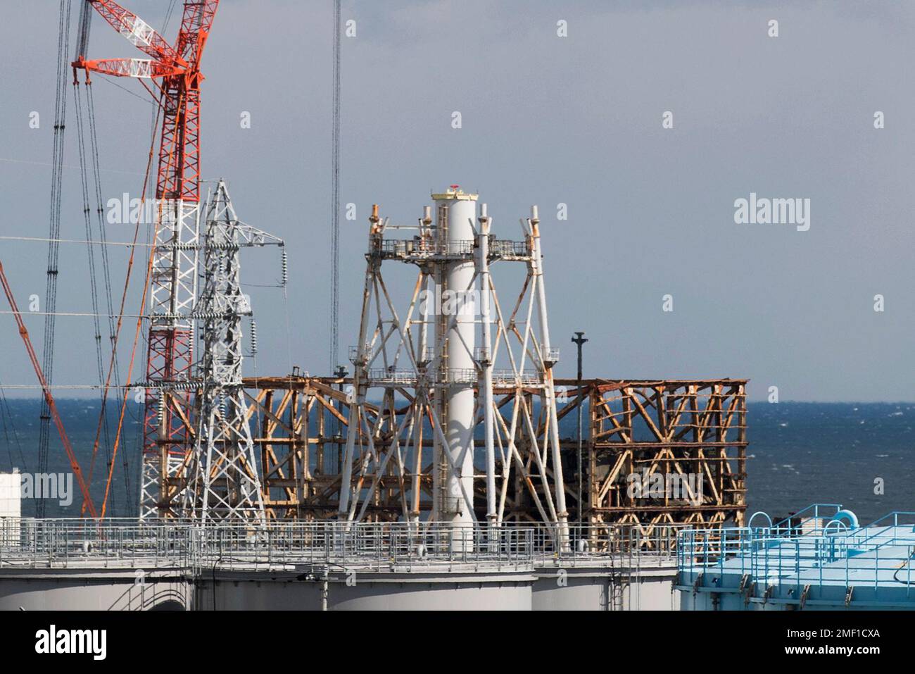 This photo shows the damaged Unit 1 reactor, back, and the exhaust ...
