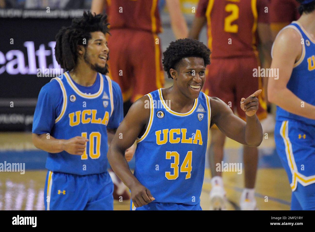 UCLA guard David Singleton, right, celebrates along with guard Tyger ...