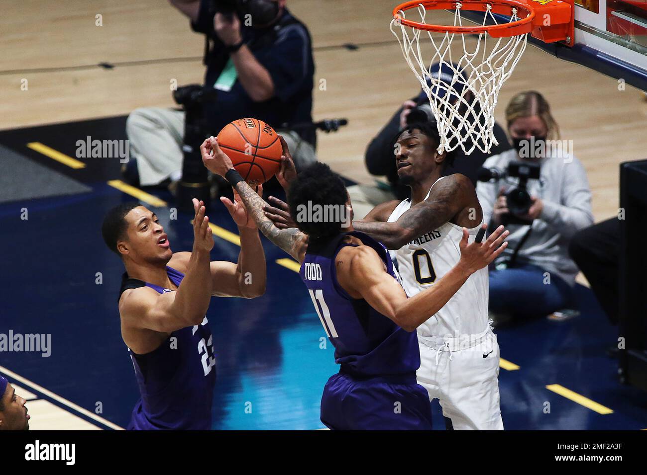 West Virginia guard Kedrian Johnson (0) is defended by TCU forward ...
