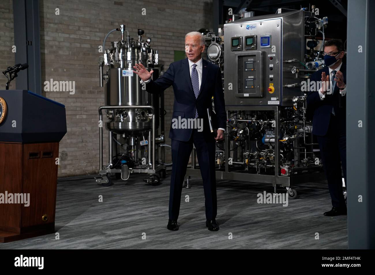 President Joe Biden waves after a tour of a Pfizer manufacturing site, Friday, Feb. 19, 2021, in ...