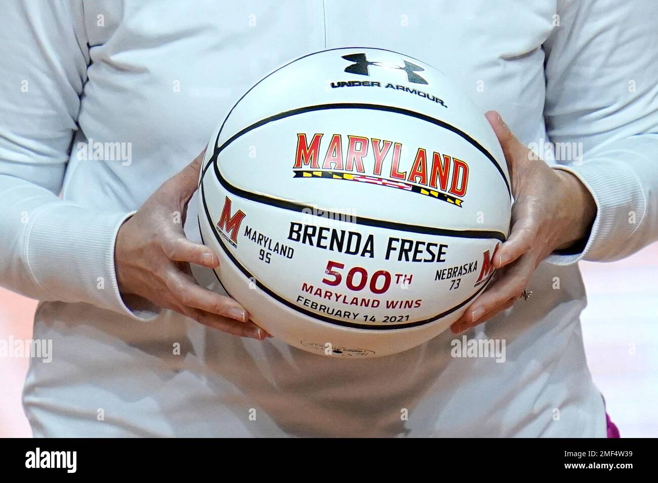 Maryland head coach Brenda Frese holds a ball after being honored ...