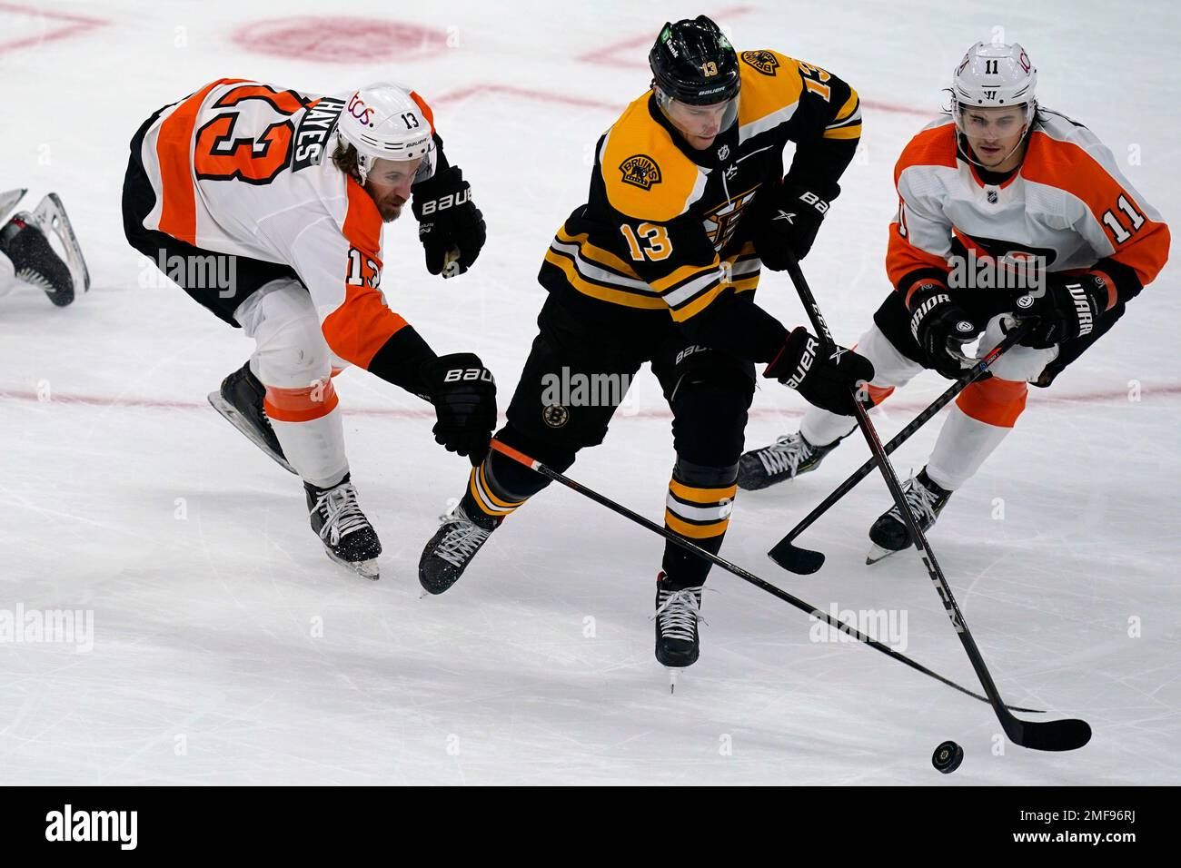 Boston Bruins center Charlie Coyle (13) chases the puck between ...