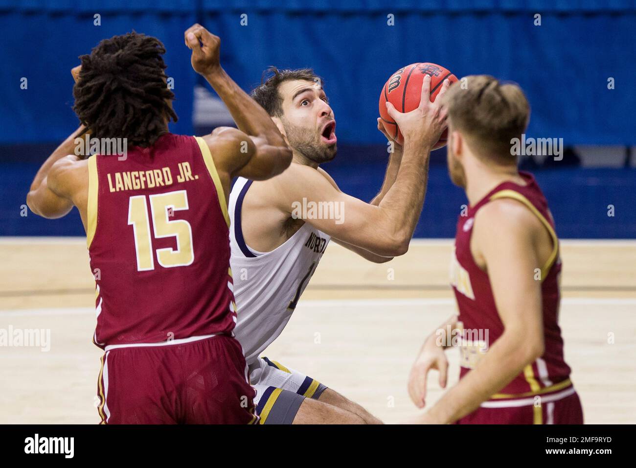 Notre Dame's Nikola Djogo, center, drives in for a layup between Boston ...