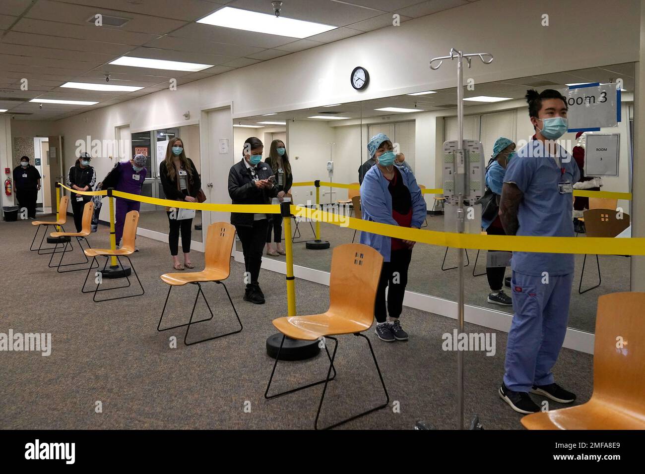 FILE - In this Dec. 24, 2020, file photo, healthcare workers wait in ...