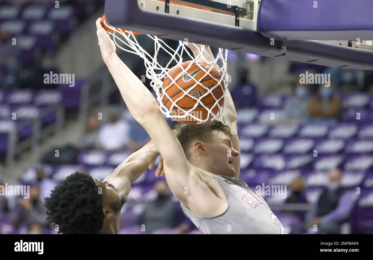 Kansas guard Christian Braun, right, dunks next to TCU center Kevin ...