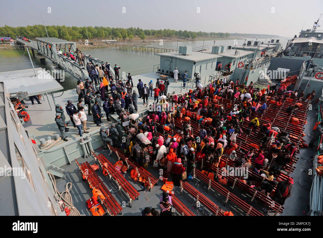 Rohingya refugees alight from a naval ship after arriving at Bhashan ...