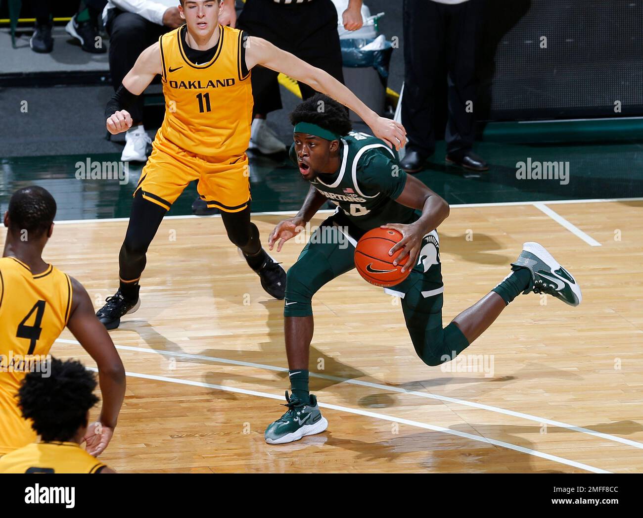 Michigan State's Gabe Brown, right, drives against Oakland's Blake ...