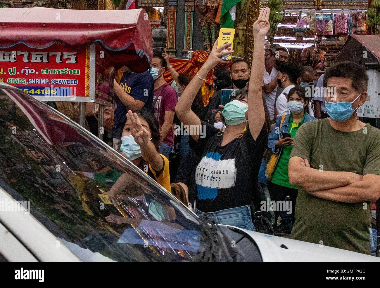 Pro-democracy demonstrators flash three finger salutes as they greet ...
