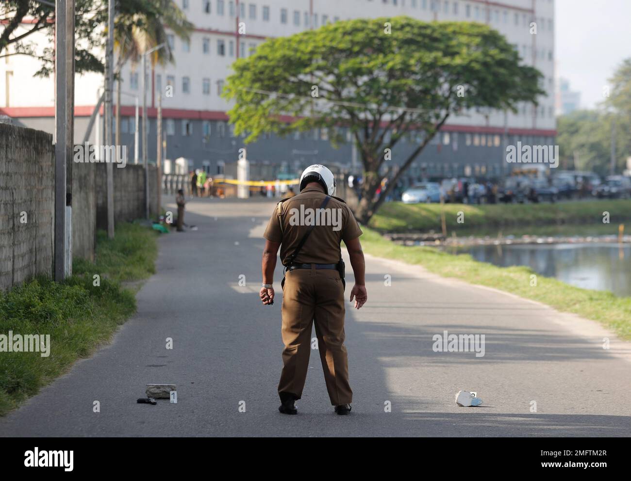 A Sri Lankan police officer stands at a crime scene following a shoot ...