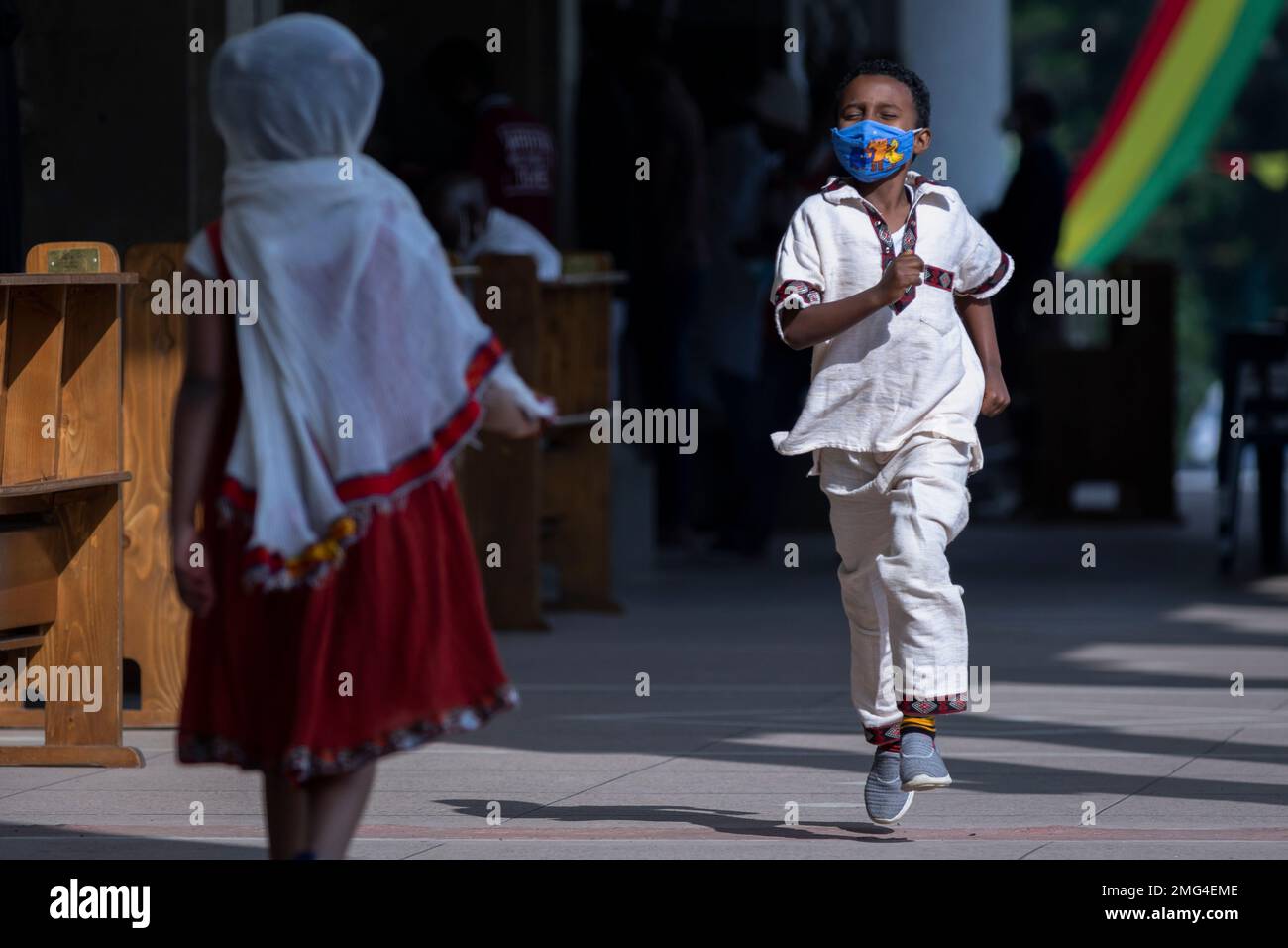 A young boy wearing a face mask to curb the spread of the coronavirus ...