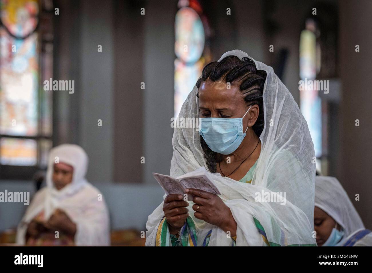 A woman wears a face mask to curb the spread of the coronavirus as she ...