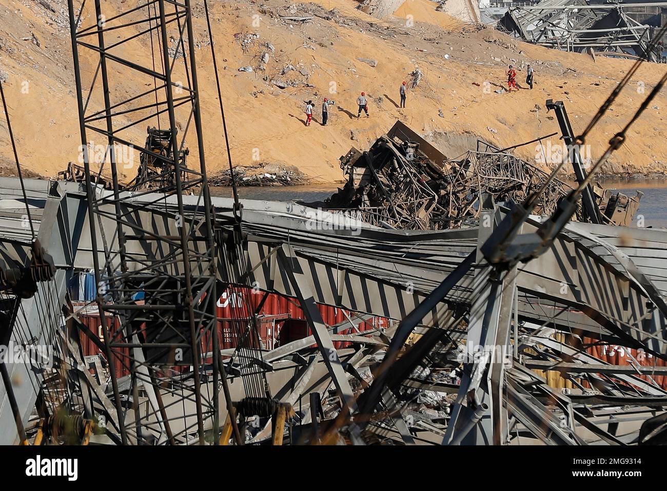 Rescue workers search for victims at the scene of Tuesday's massive ...