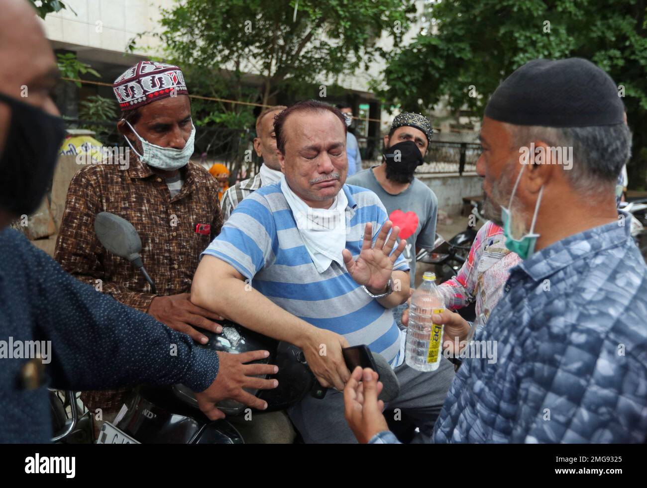 Relatives of patients wait for news outside Shrey hospital, where a ...