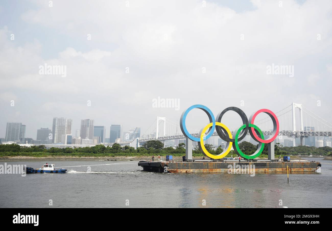 A tugboat moves a symbol installed for the Olympic and Paralympic Games ...