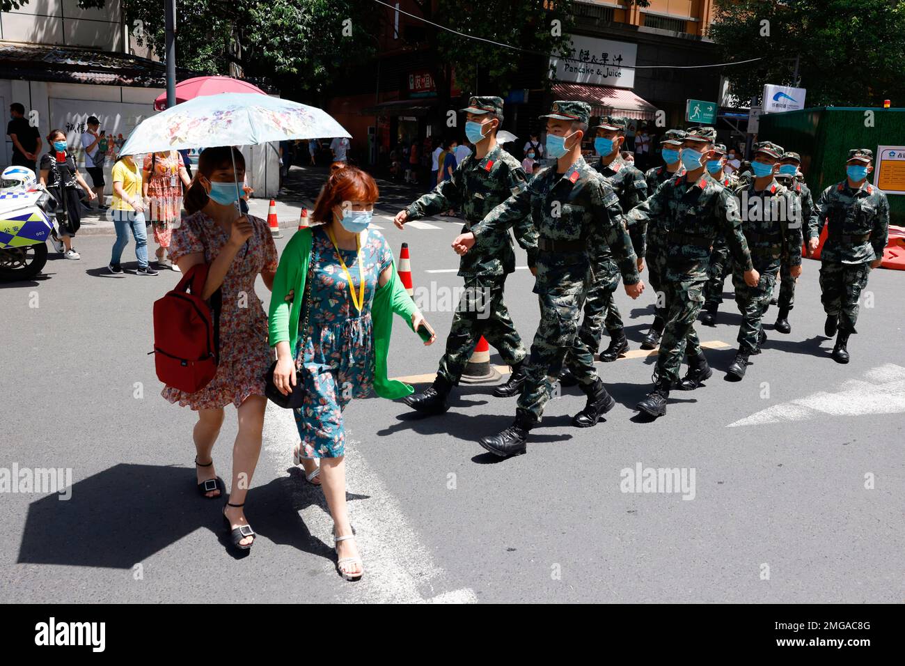 Chinese paramilitary policemen march near the United States Consulate ...