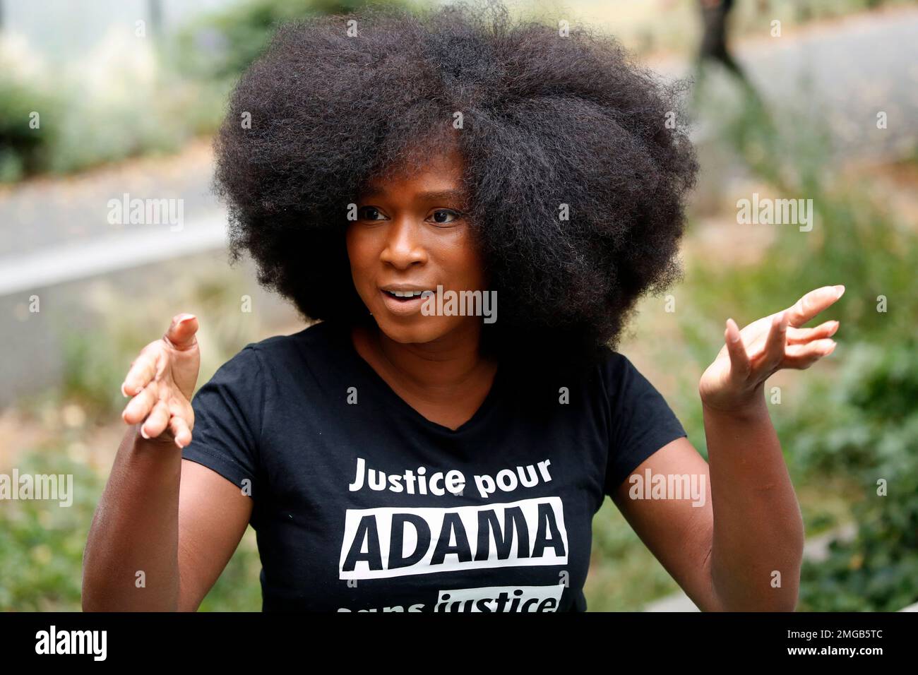 Assa Traore, wearing a shirt that reads: â€œJustice for Adama, without ...