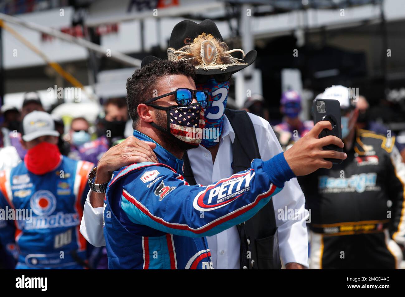 Team owner Richard Petty, right, poses for a selfie with driver Bubba ...
